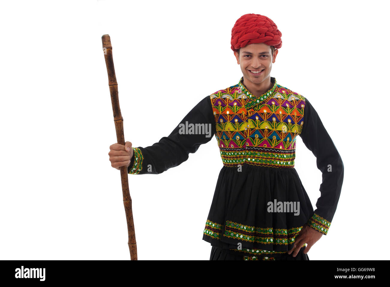 Portrait of a male dandiya dancer with a stick Stock Photo - Alamy
