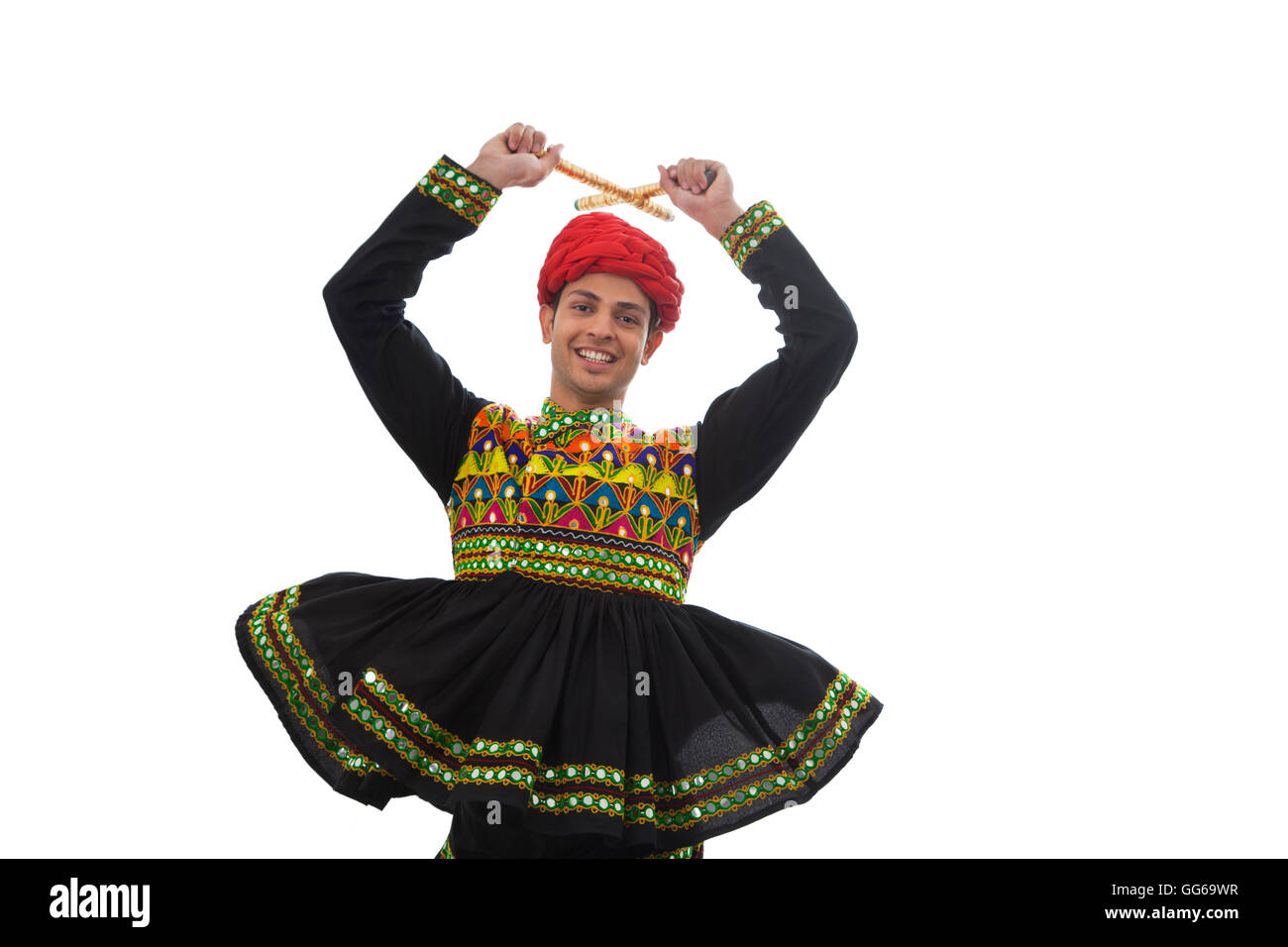 Male dandiya dancer dancing with sticks Stock Photo - Alamy