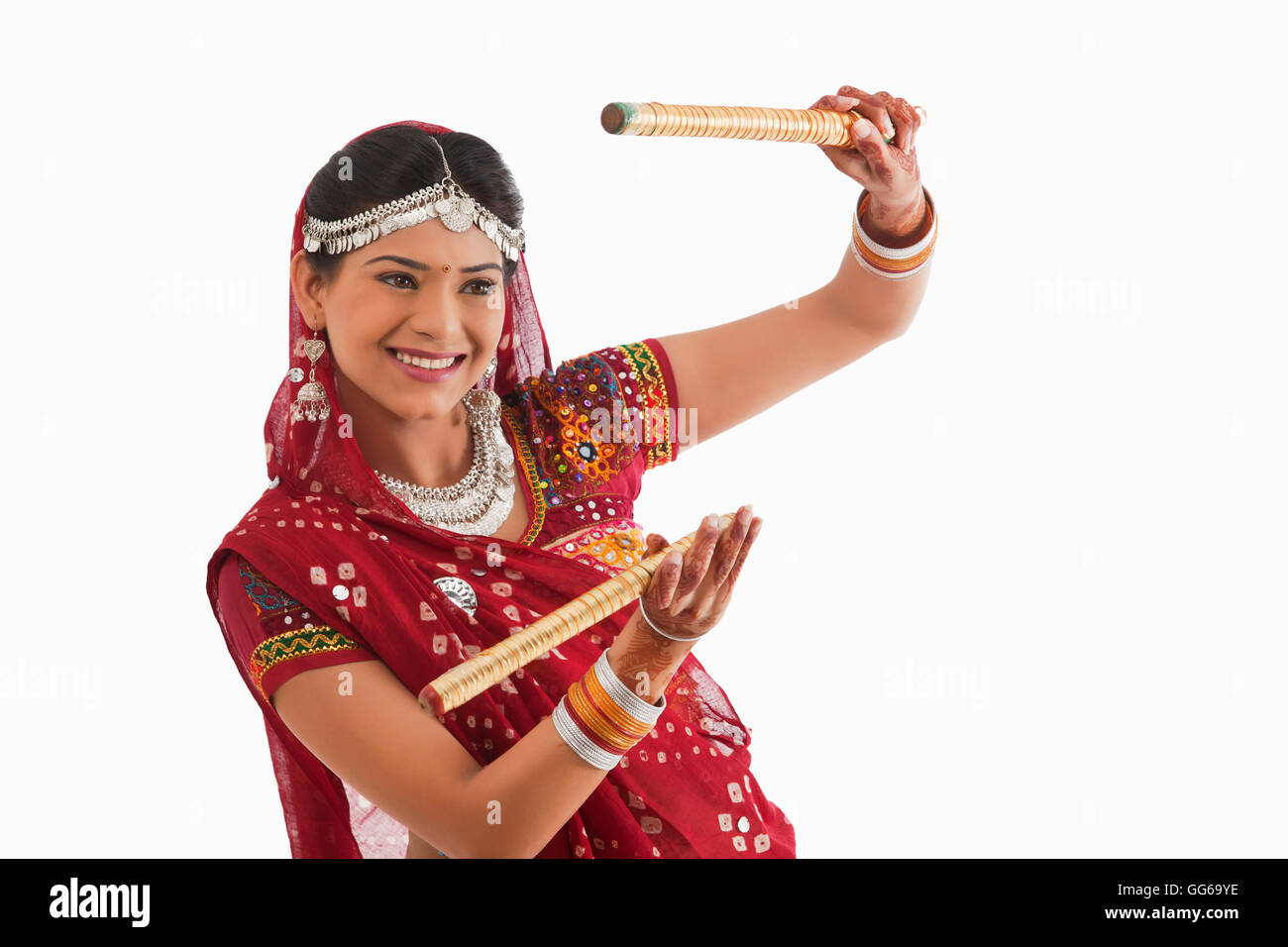 Female dandiya dancer dancing with sticks Stock Photo - Alamy