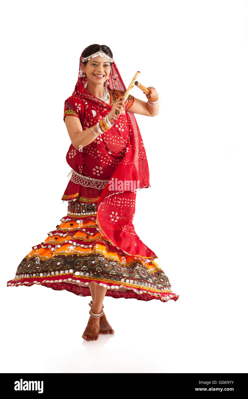 Female dandiya dancer dancing with sticks Stock Photo - Alamy