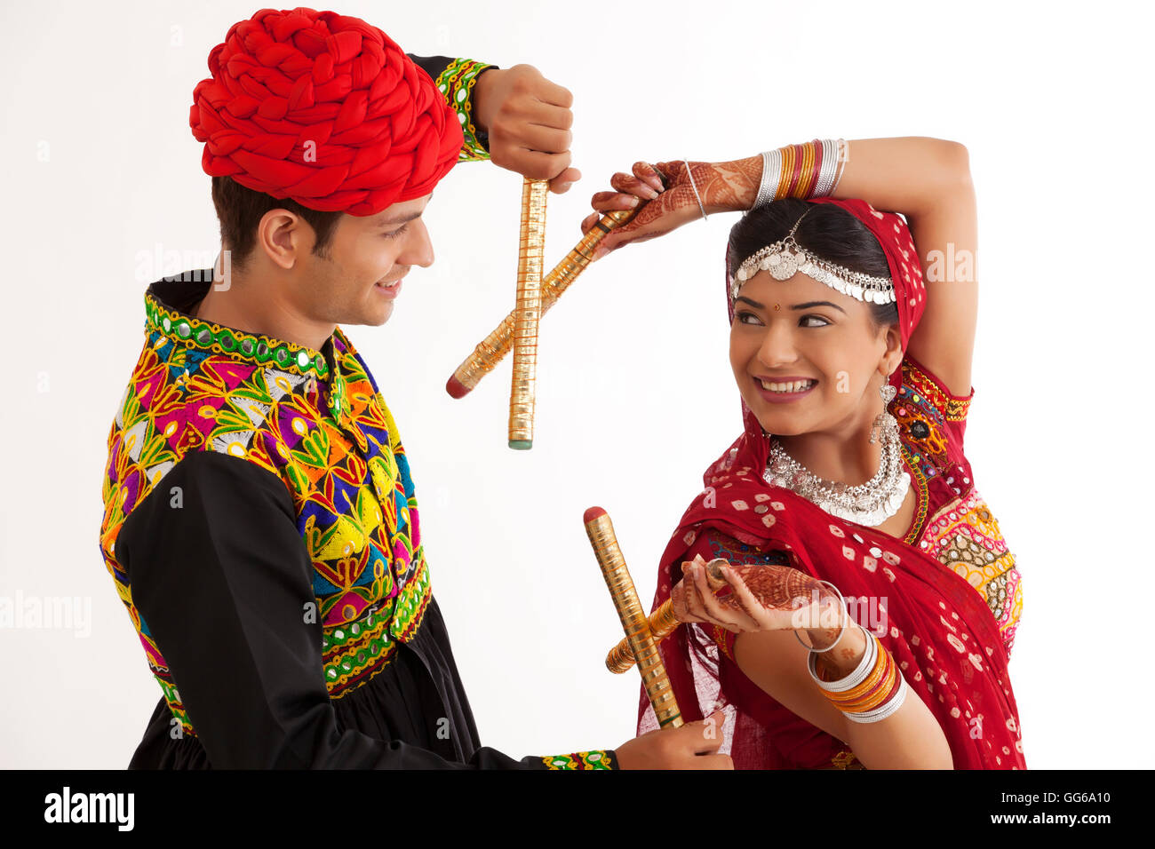 Couple with sticks dancing Stock Photo - Alamy