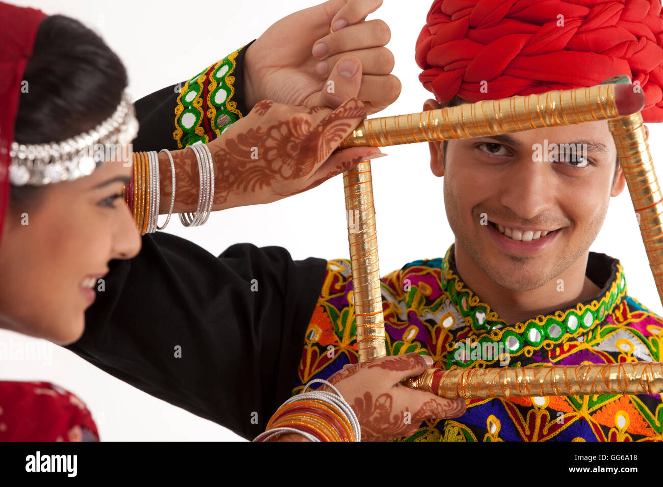 Couple with sticks dancing Stock Photo - Alamy