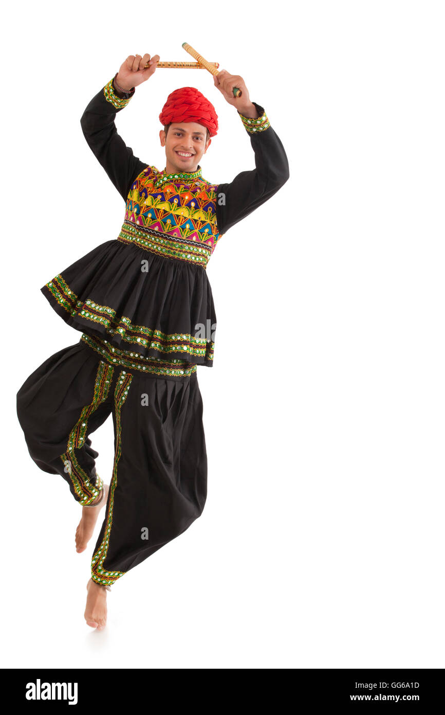 Male dandiya dancer dancing with sticks Stock Photo - Alamy