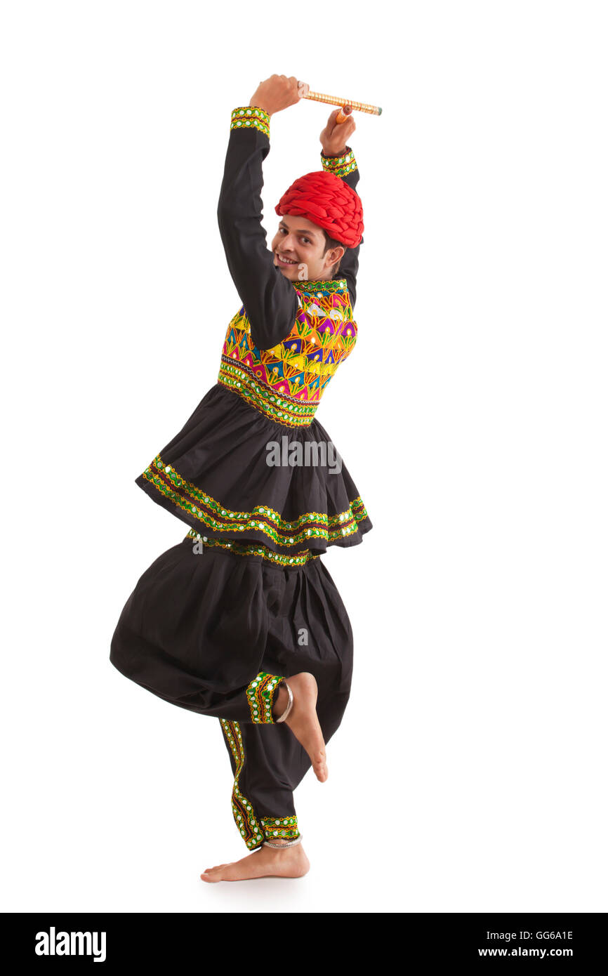 Male dandiya dancer dancing with sticks Stock Photo - Alamy