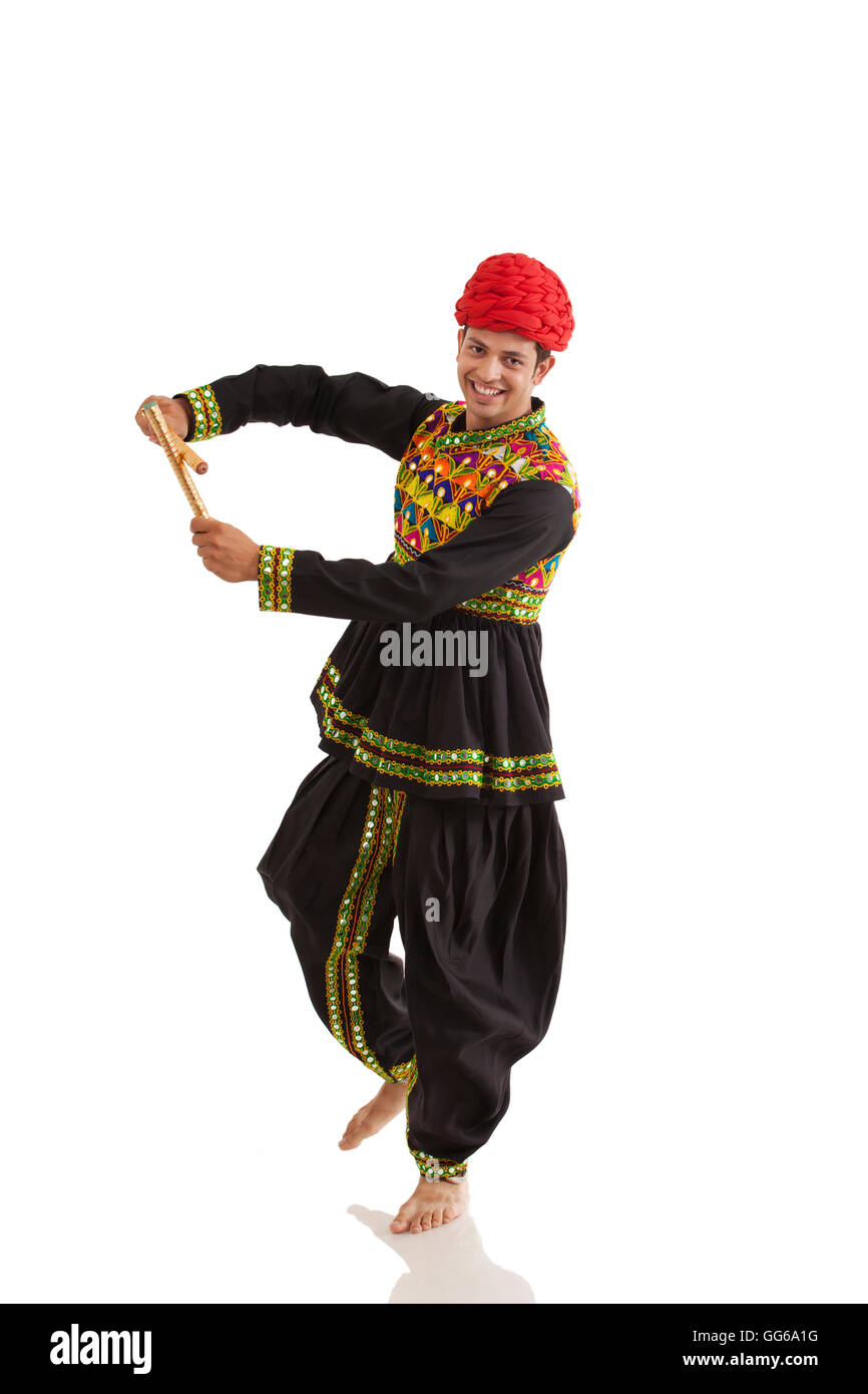 Male dandiya dancer dancing with sticks Stock Photo - Alamy