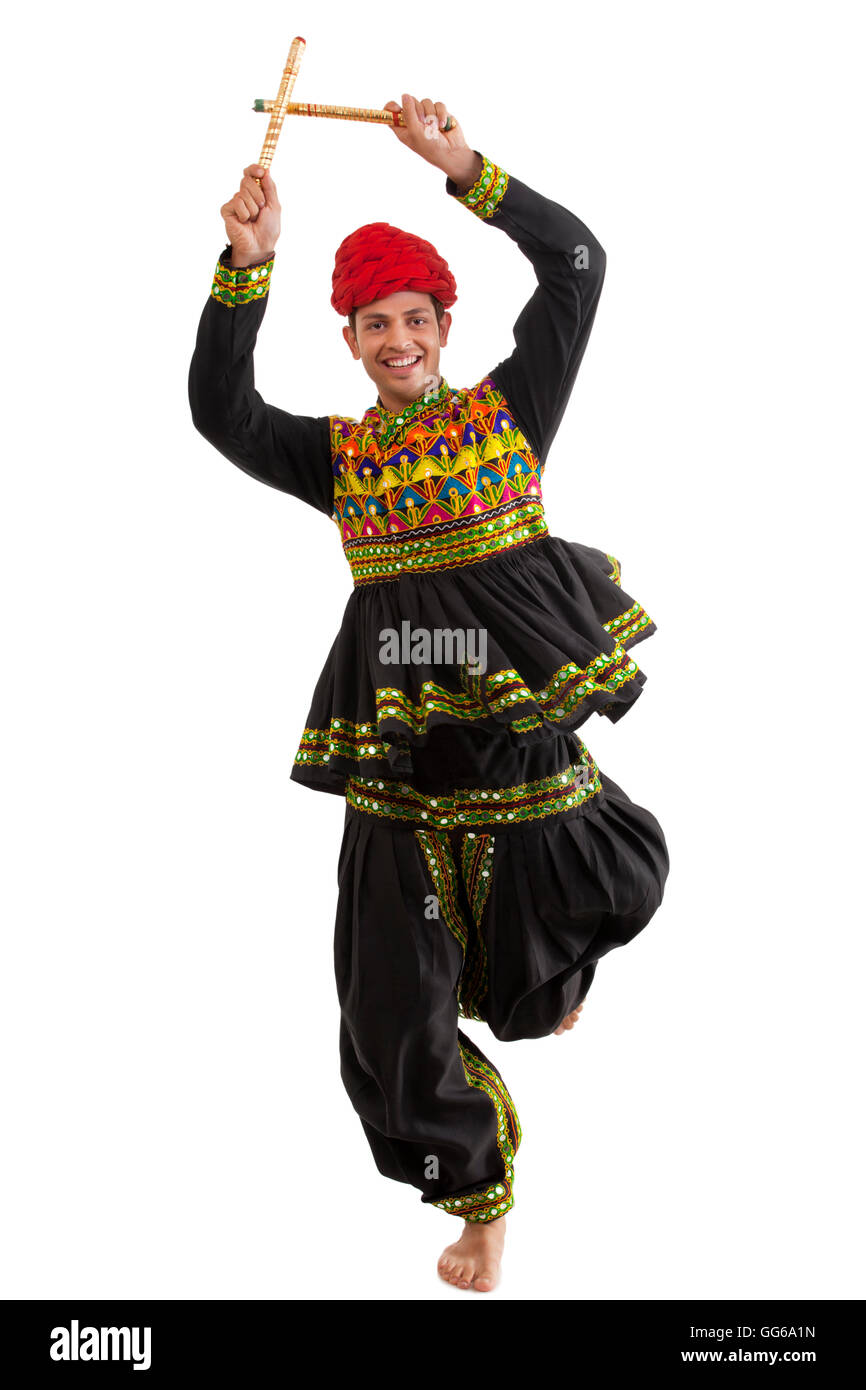 Male dandiya dancer dancing with sticks Stock Photo - Alamy