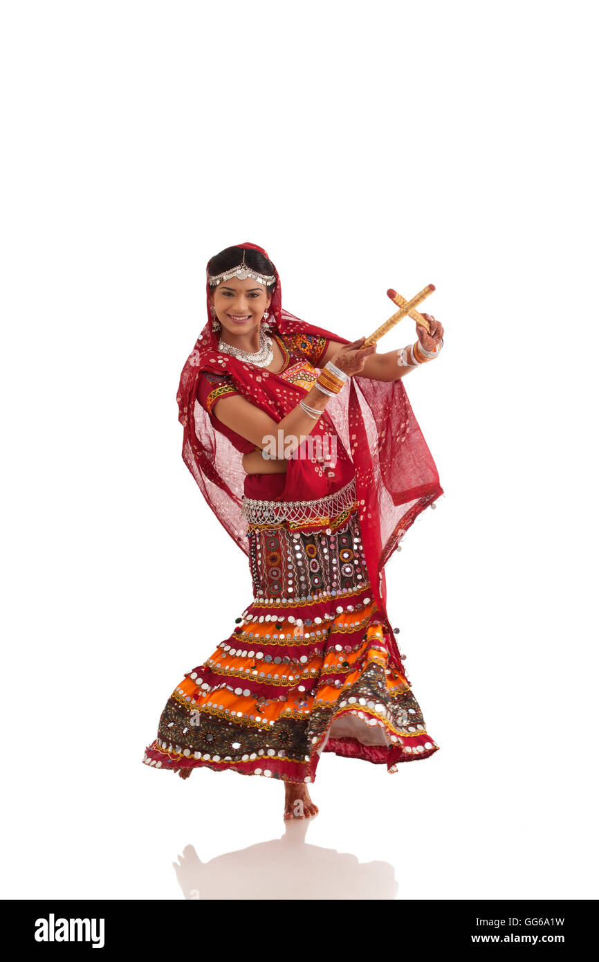 Female dandiya dancer dancing with sticks Stock Photo - Alamy