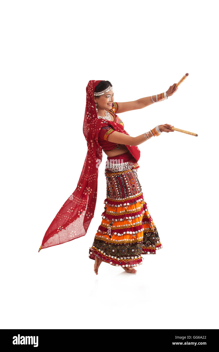 Female dandiya dancer dancing with sticks Stock Photo - Alamy