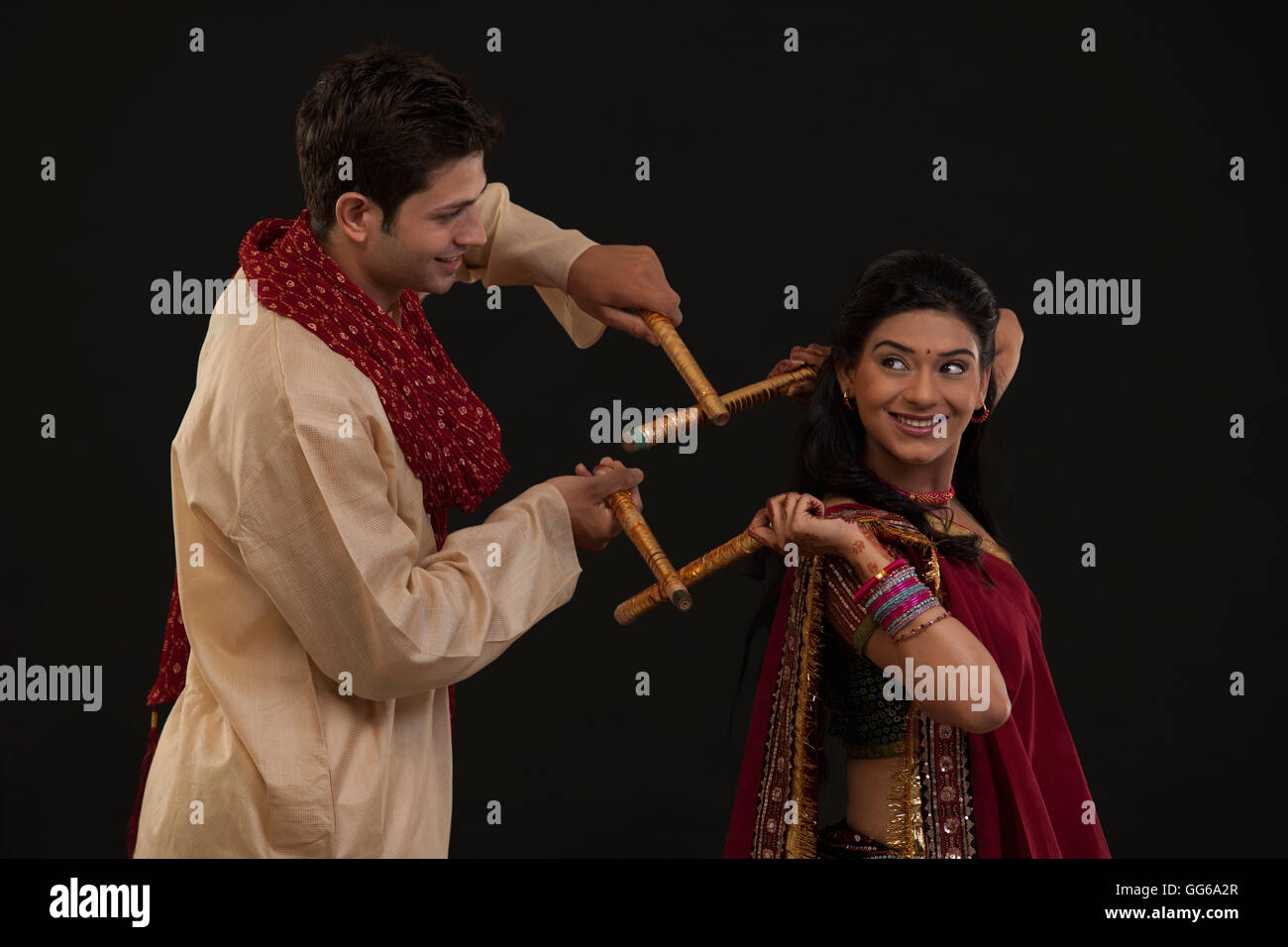 Couple with sticks dancing Stock Photo - Alamy