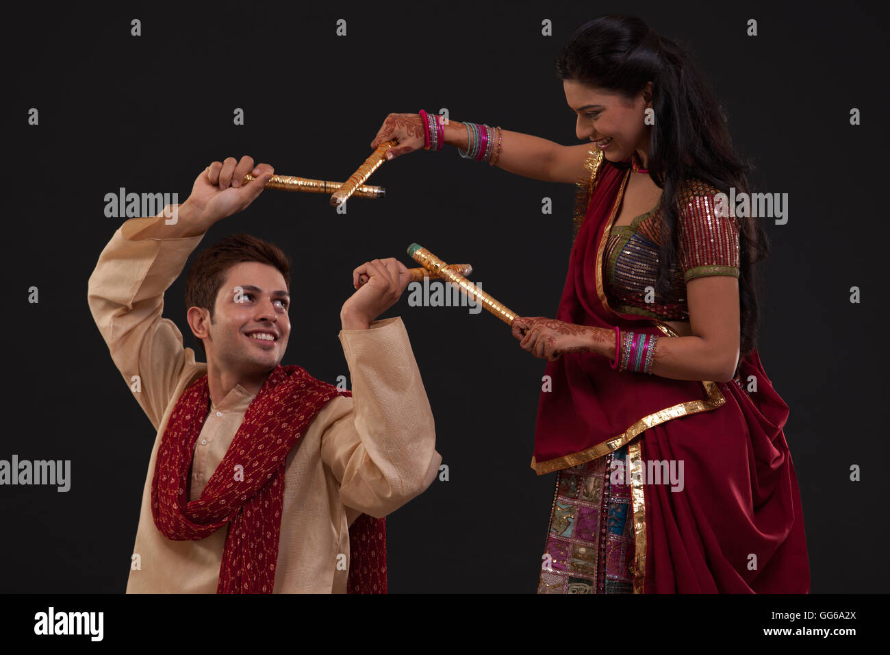 Couple with sticks dancing Stock Photo - Alamy