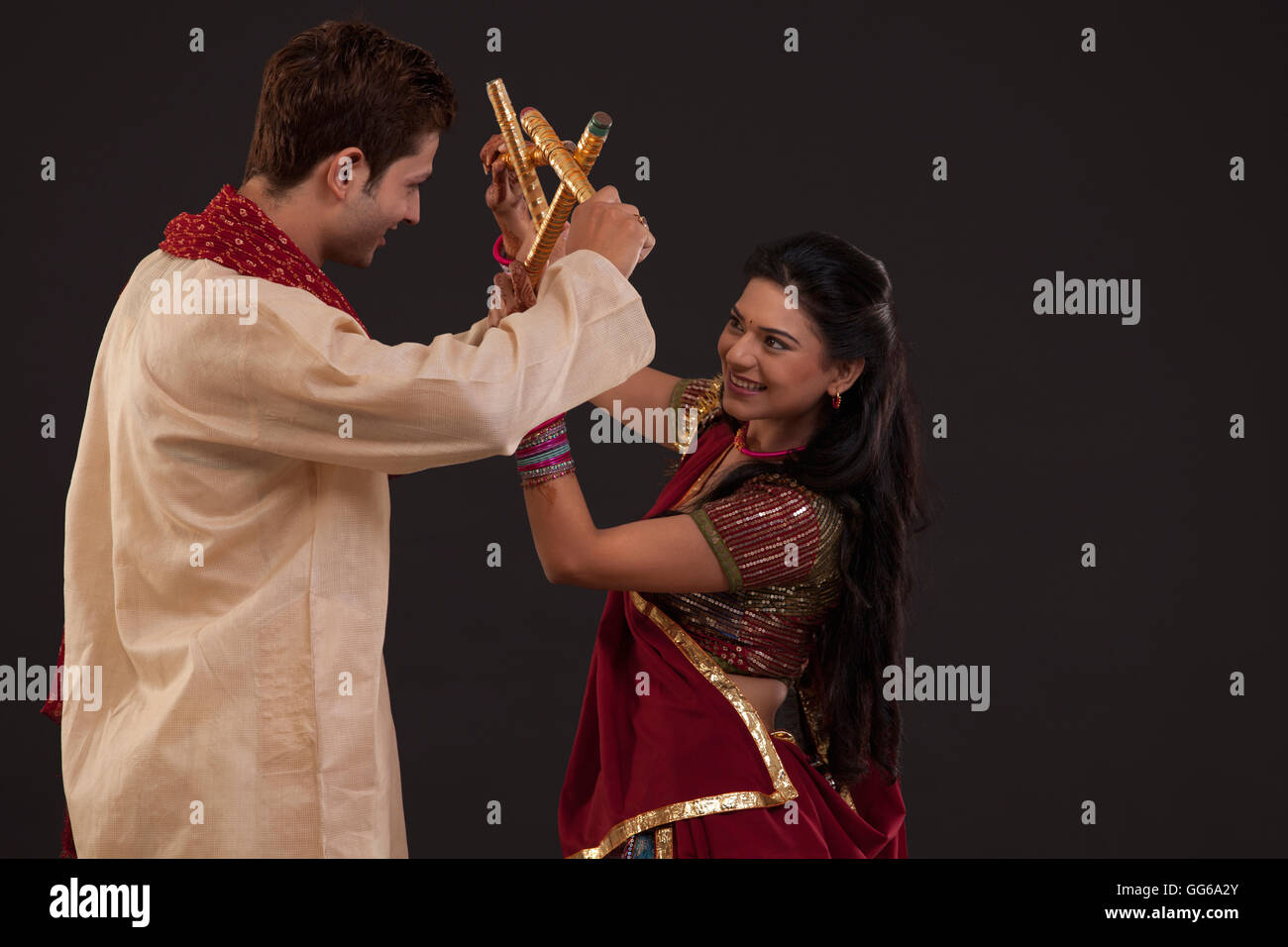 Couple with sticks dancing Stock Photo - Alamy