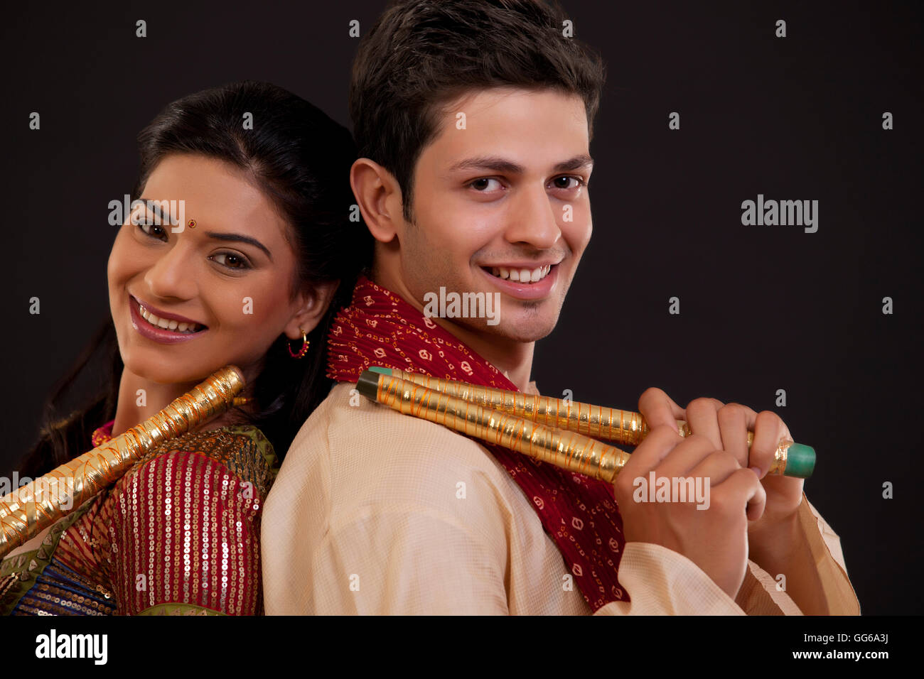 Portrait of couple with sticks Stock Photo - Alamy