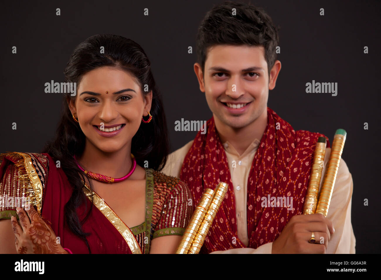 Portrait of couple with sticks Stock Photo - Alamy