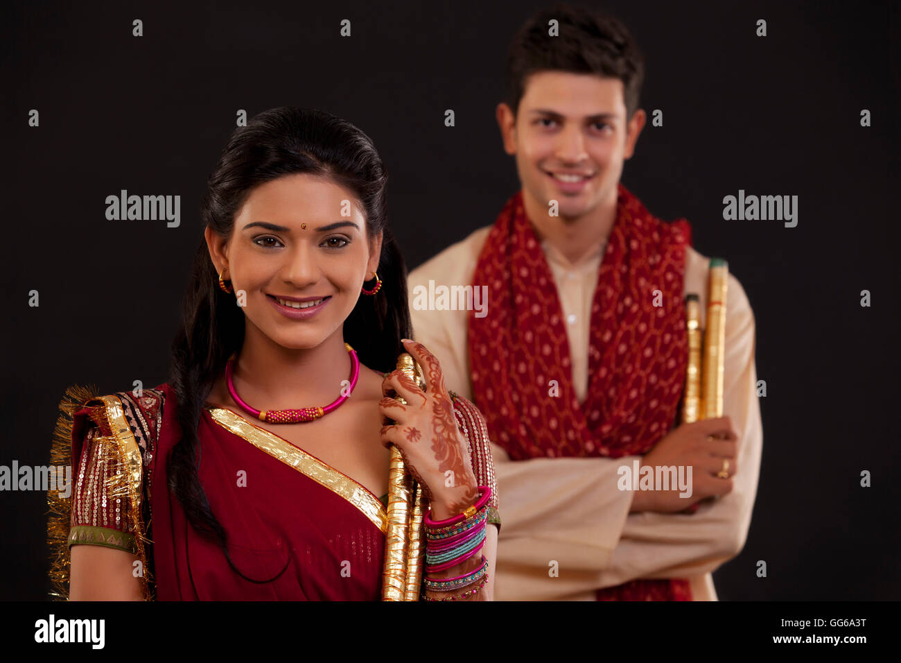 Portrait of couple with sticks Stock Photo - Alamy