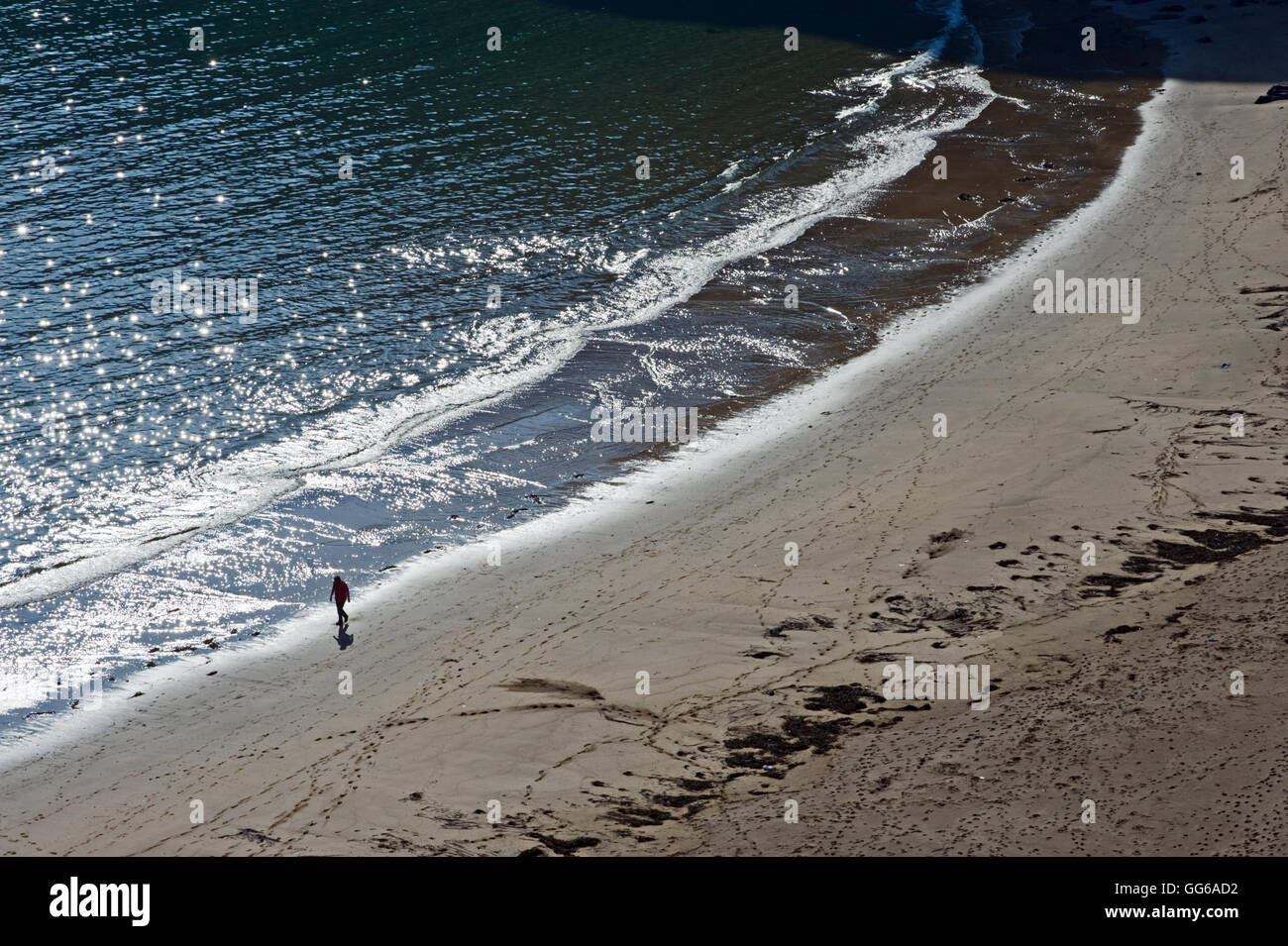 Solitary backlit figure on beach, Silver Strand, Donegal Stock Photo ...