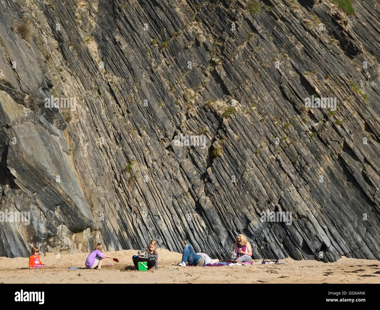 Family on Donegal beach with folded rock strata Stock Photo - Alamy