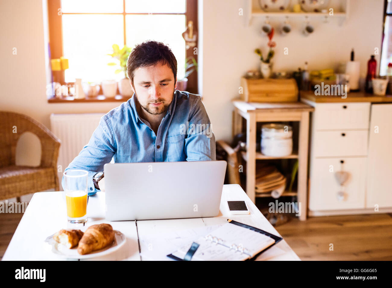 Man sitting working wooden table hi-res stock photography and images ...