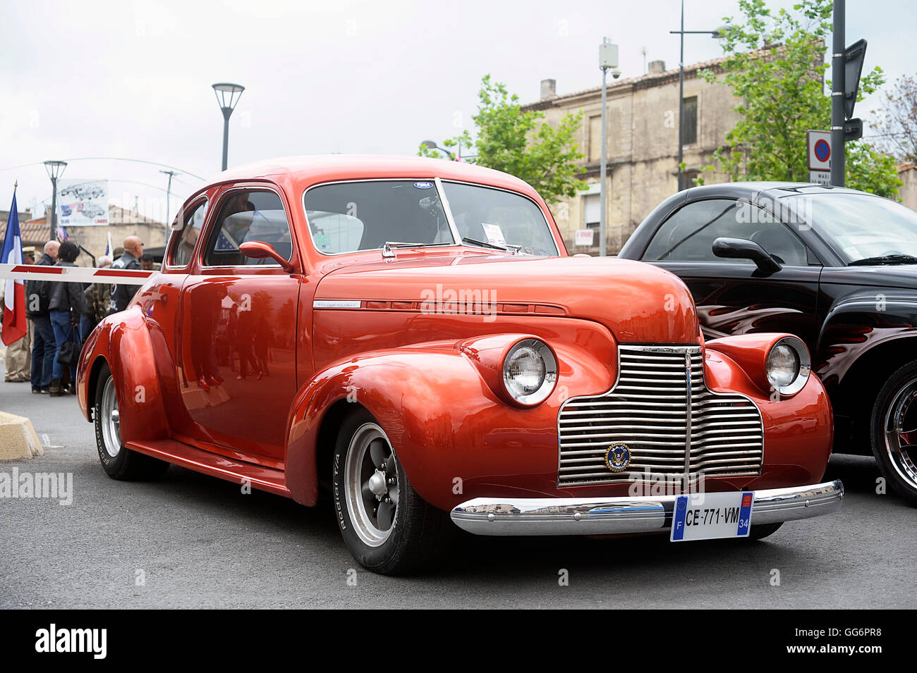 orange hot rod parked in a gathering of American motorcycles in ...