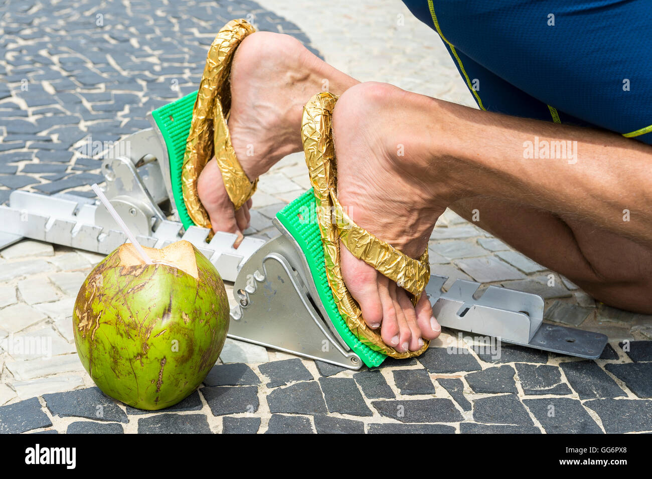 Brazilian athlete wearing flip flops crouching at the start position in ...