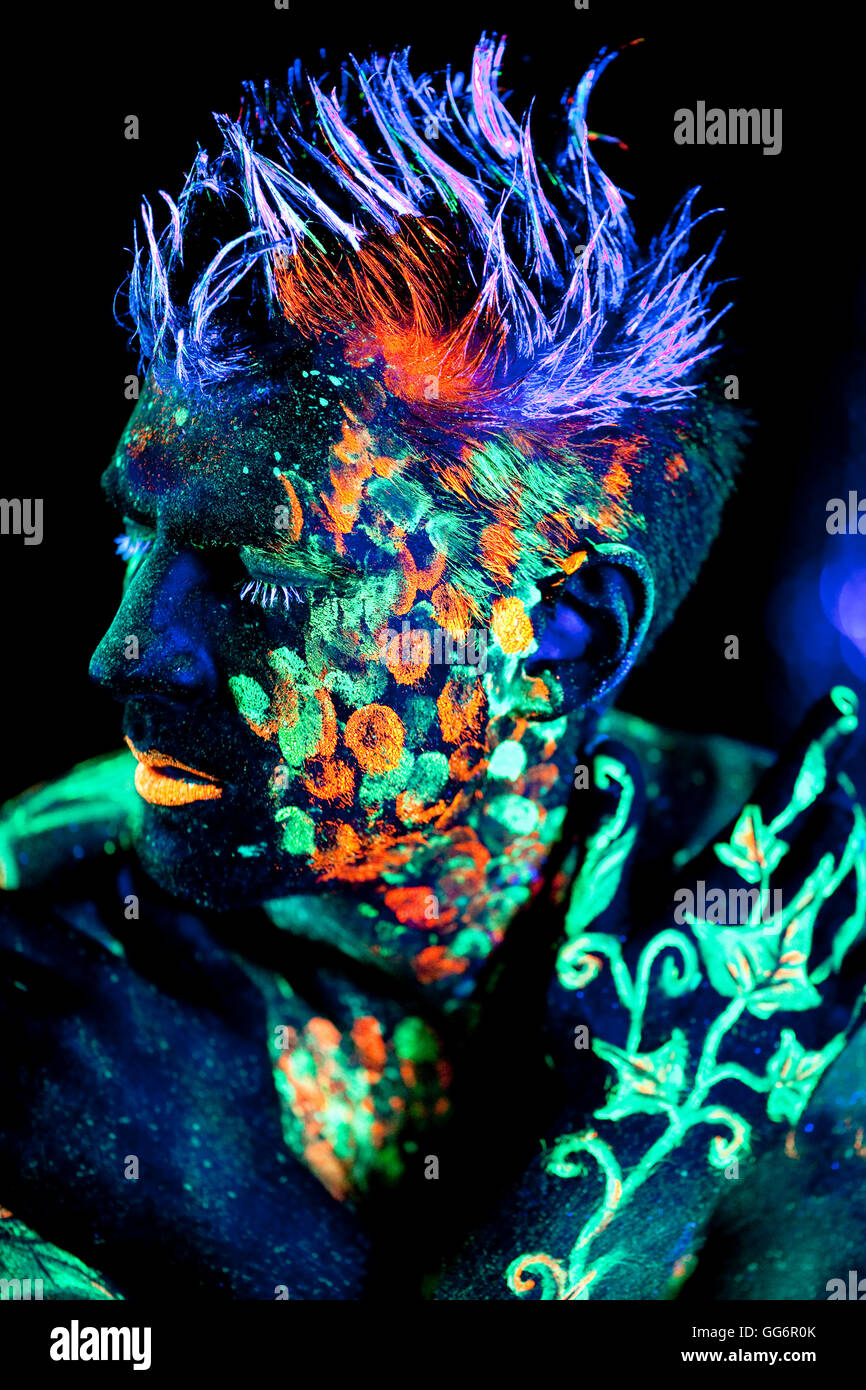 Body art glowing in ultraviolet light Stock Photo - Alamy