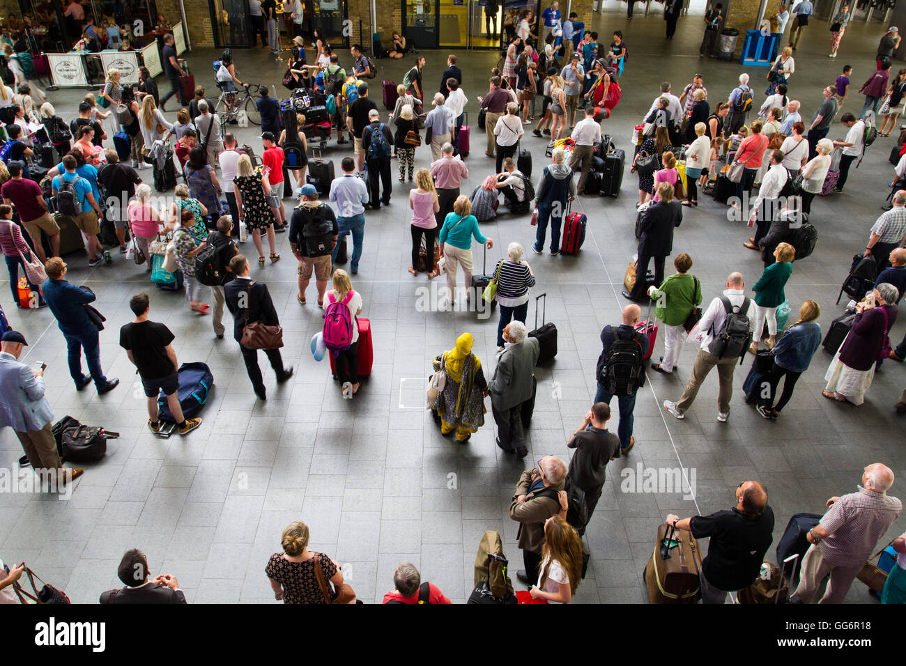 Looking down from above onto a crowded King's Cross Train Station ...