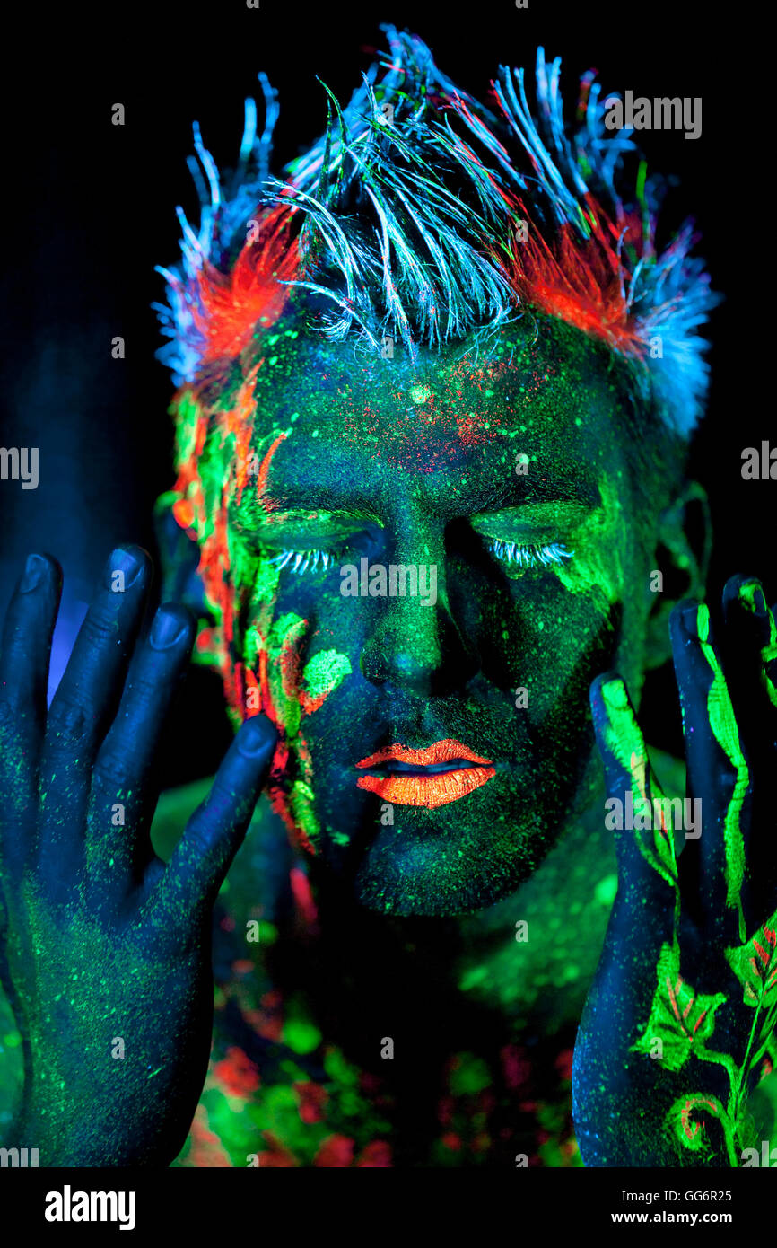 Body art glowing in ultraviolet light Stock Photo - Alamy