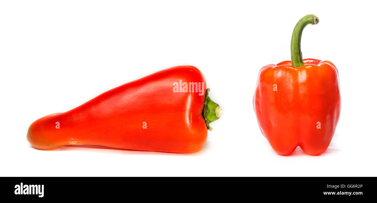 two red peppers of different shapes on white background Stock Photo - Alamy