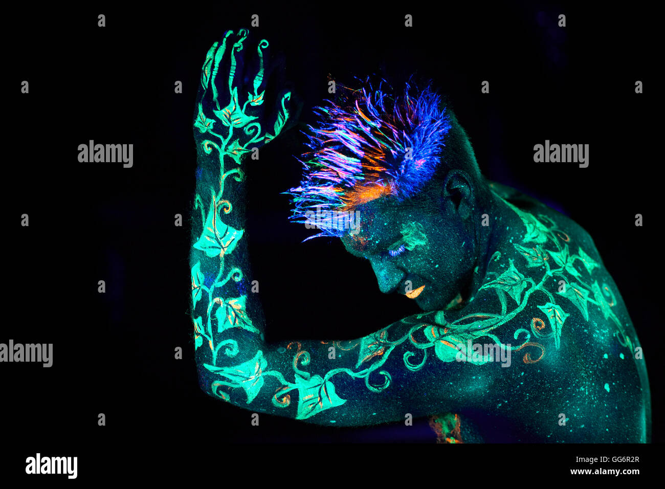 Body art glowing in ultraviolet light Stock Photo - Alamy