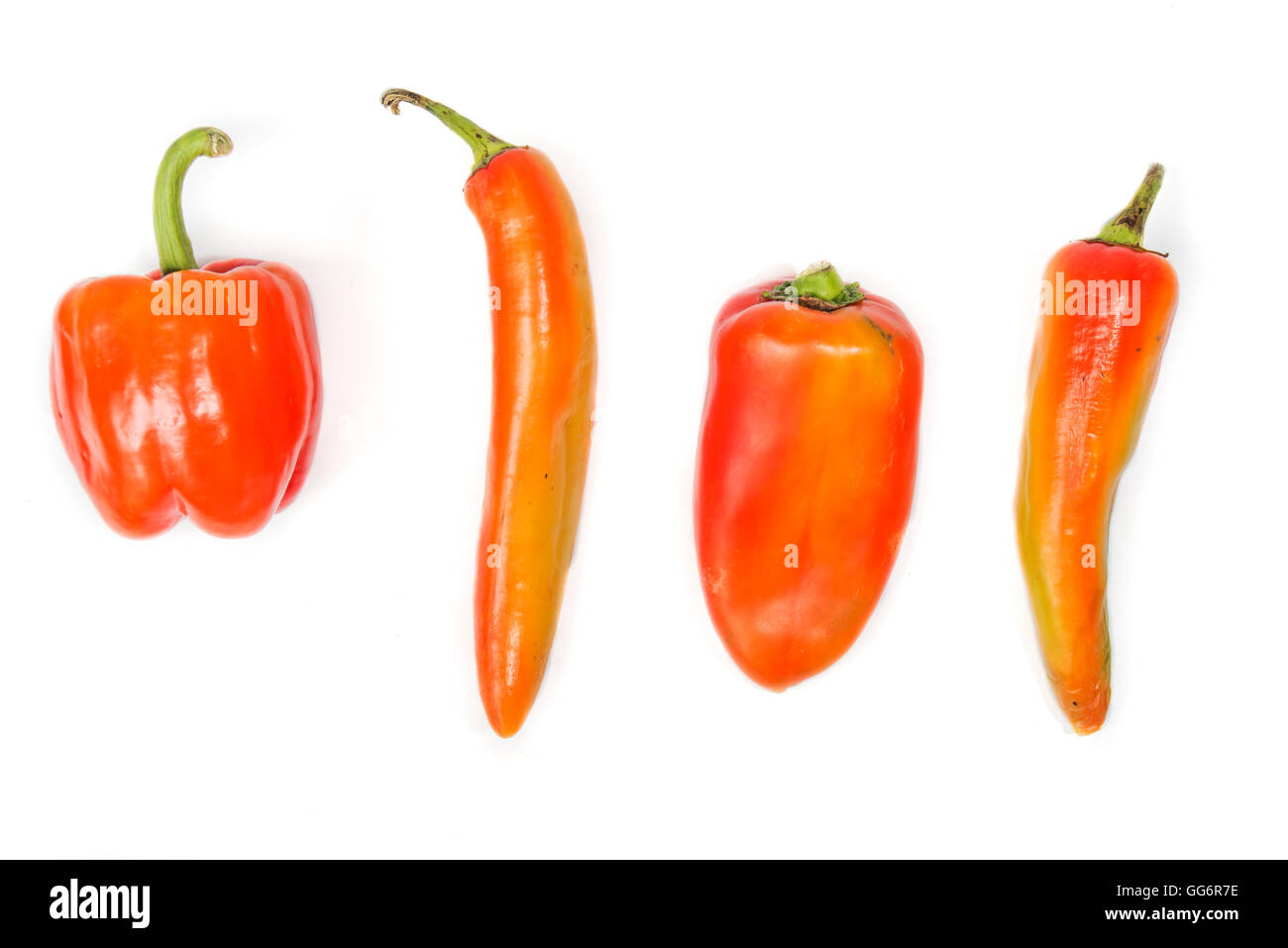 four red peppers of different shapes on white background Stock Photo ...