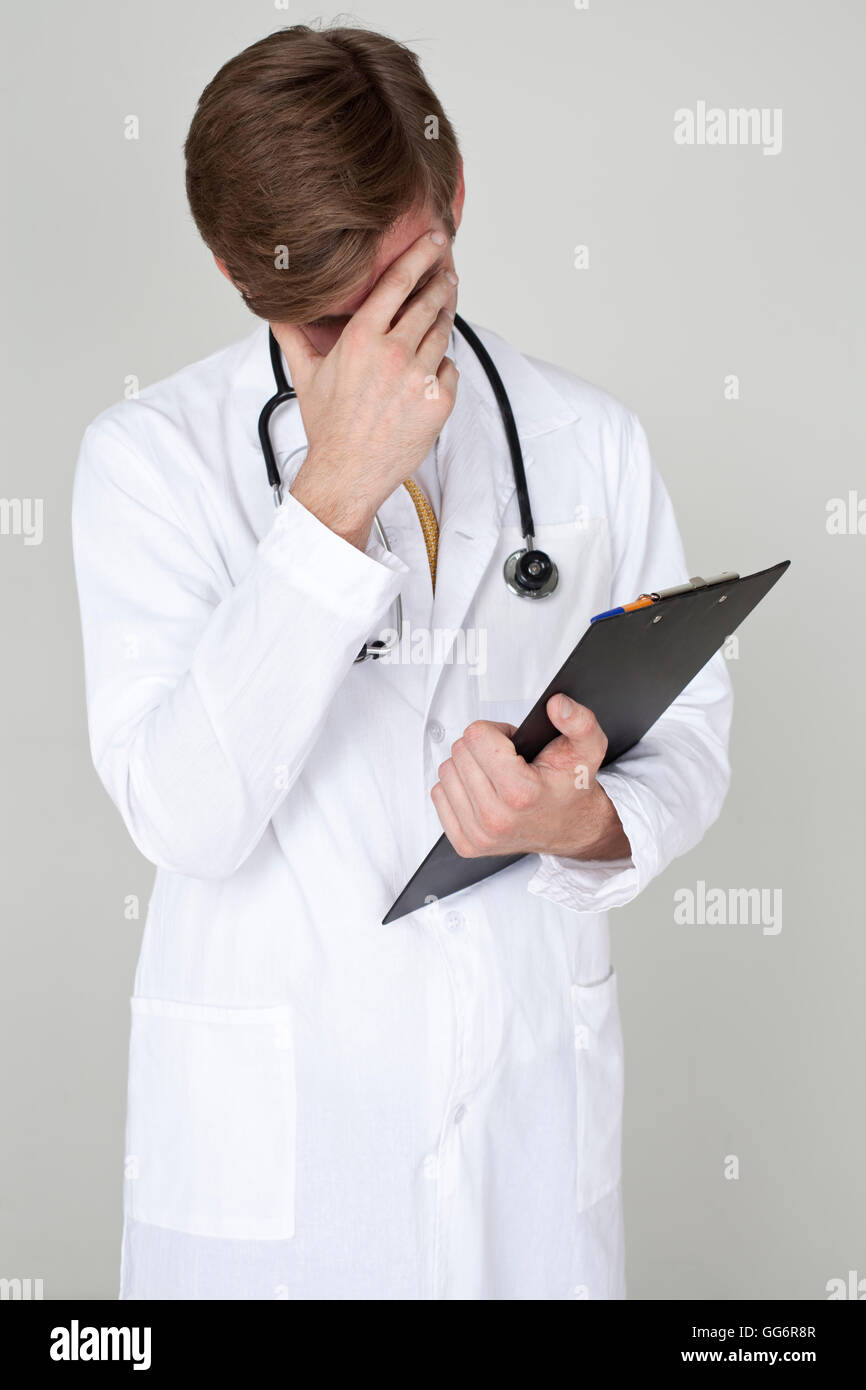 Sad young male doctor hi-res stock photography and images - Alamy