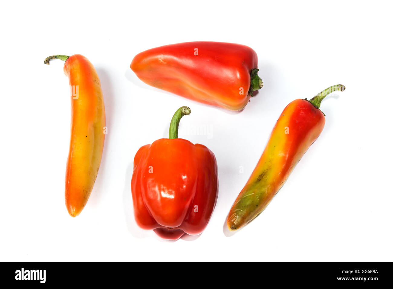 four red peppers of different shapes on white background Stock Photo ...