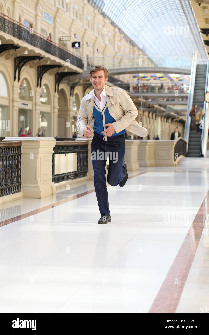 Young man running in the store Stock Photo - Alamy
