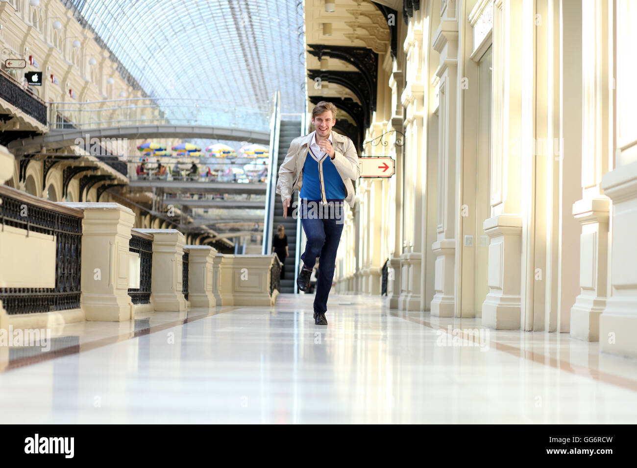 Young man running in the store Stock Photo - Alamy