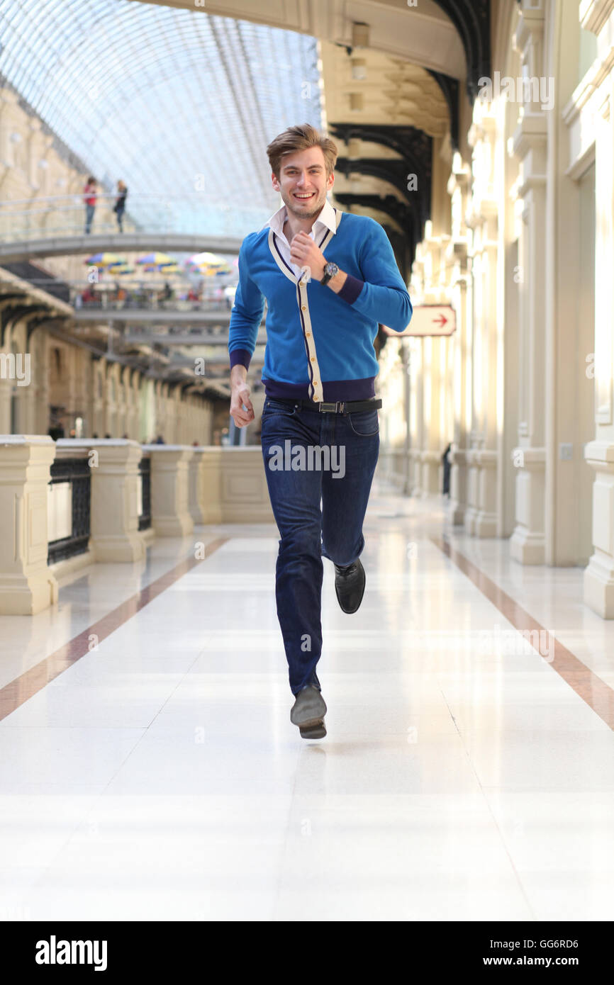 Young man running in the store Stock Photo - Alamy