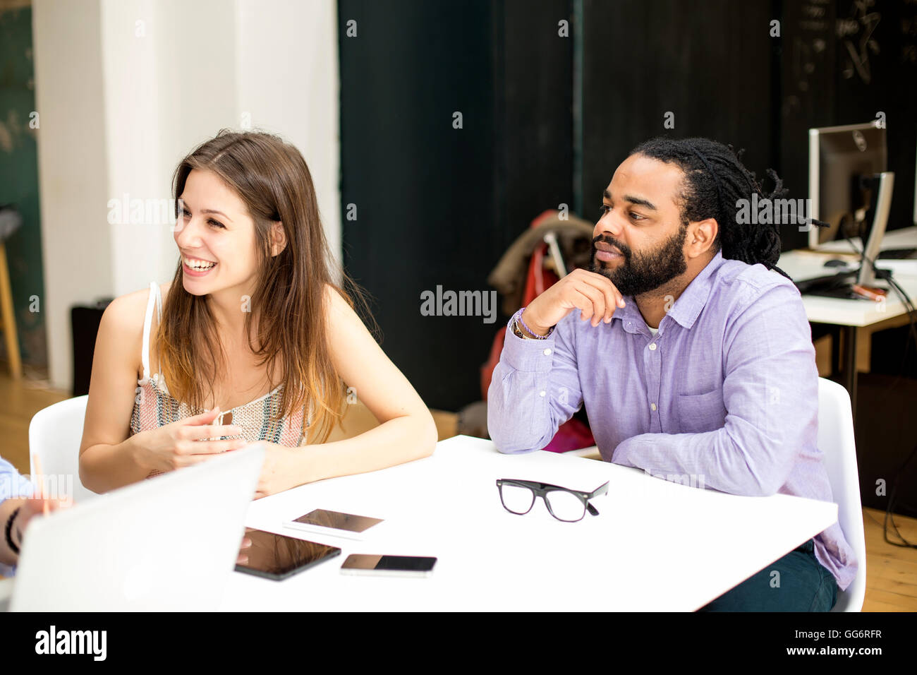 Young people working by the desk in the grunge office Stock Photo - Alamy