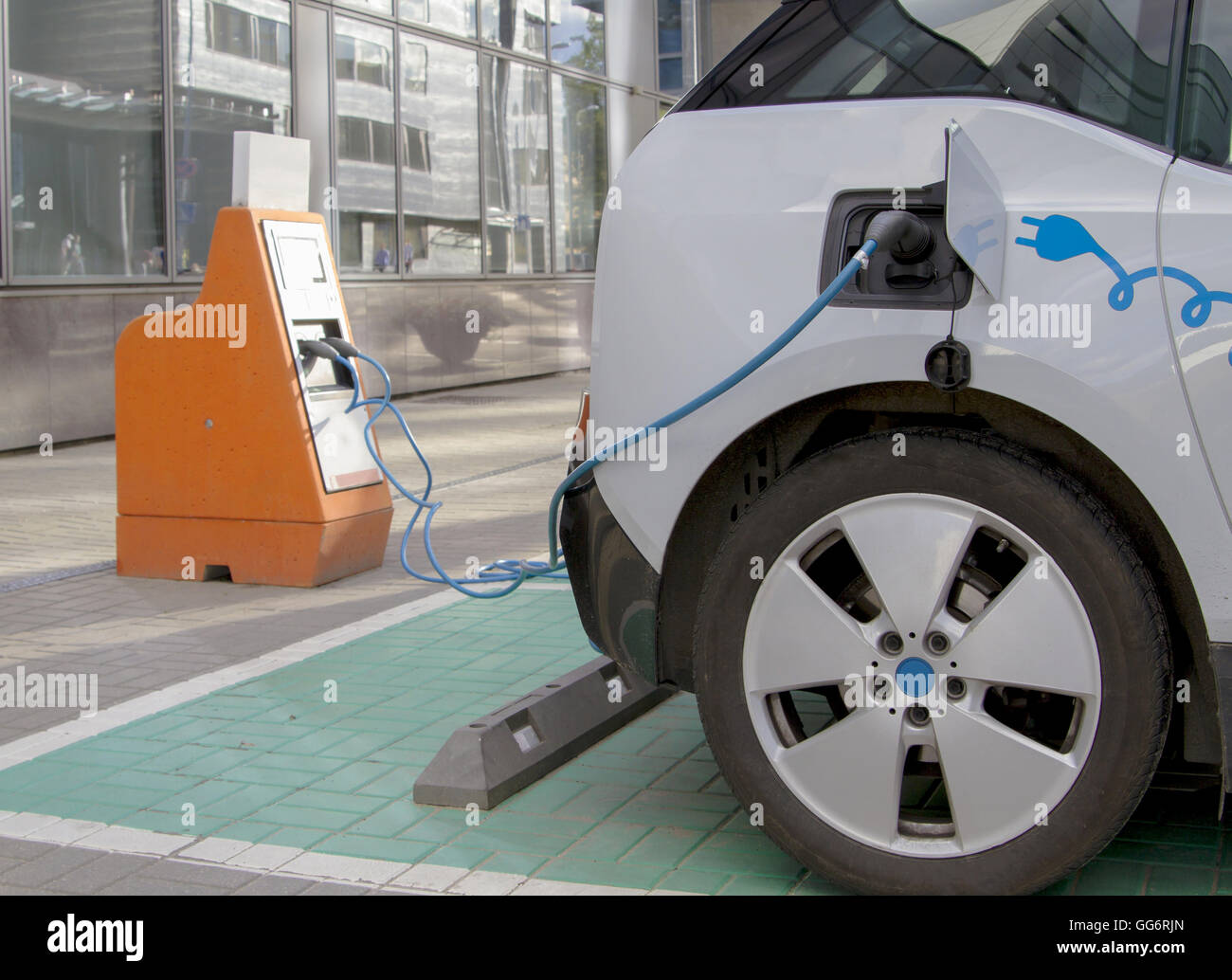 Electric car charging station. Close up of the power supply plugged ...