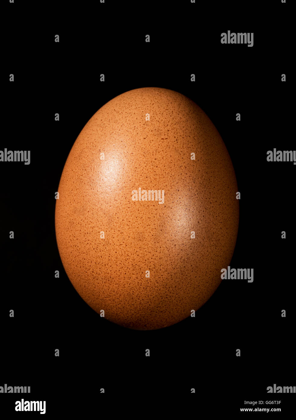 red hen egg isolated on black background Stock Photo - Alamy