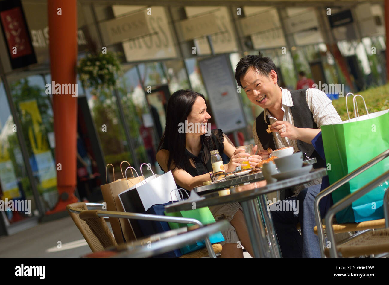 Young adult couple having brunch at a retail outlet. England. UK Stock ...