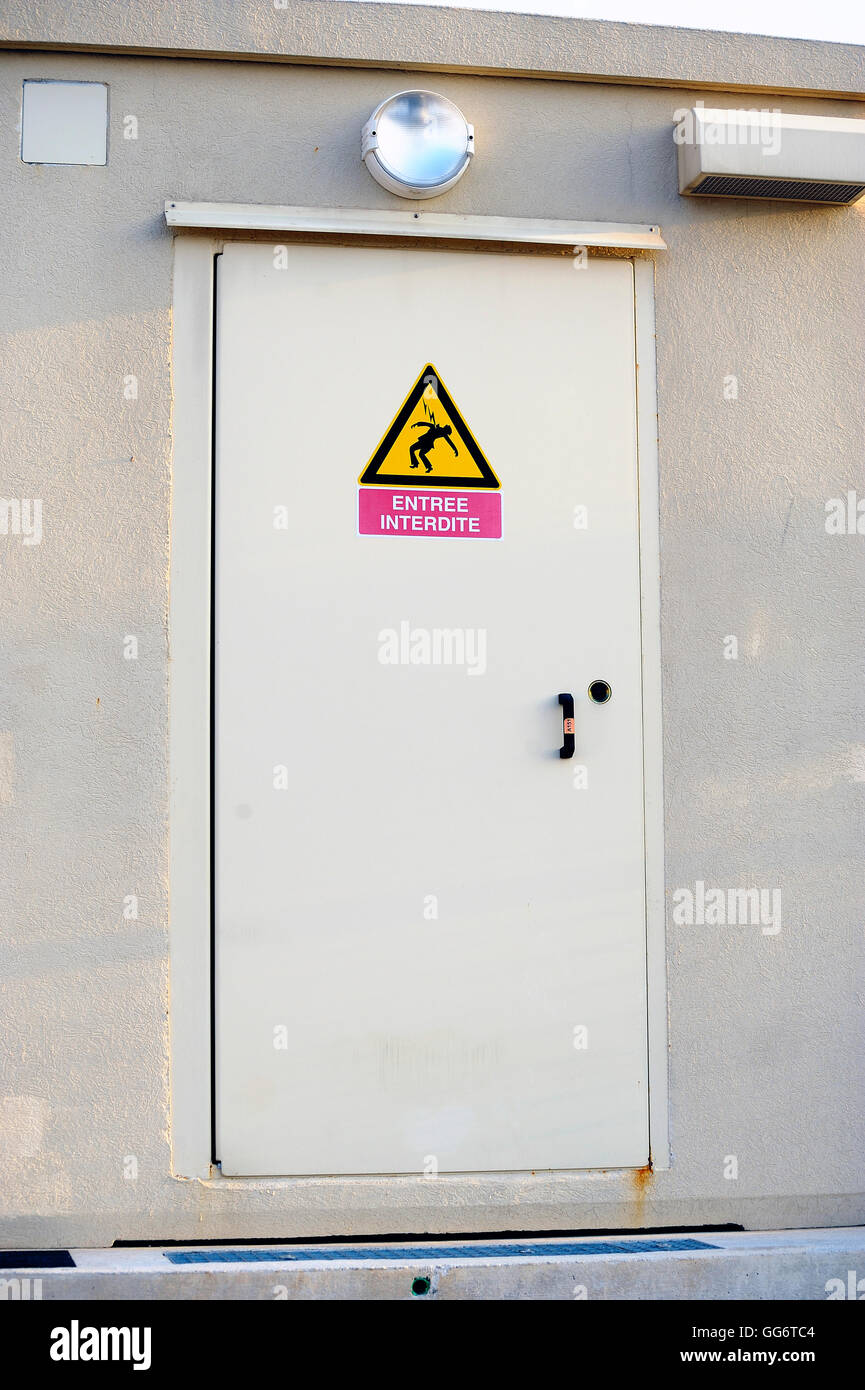 Gateway to an electric high-voltage transformer with danger message on ...