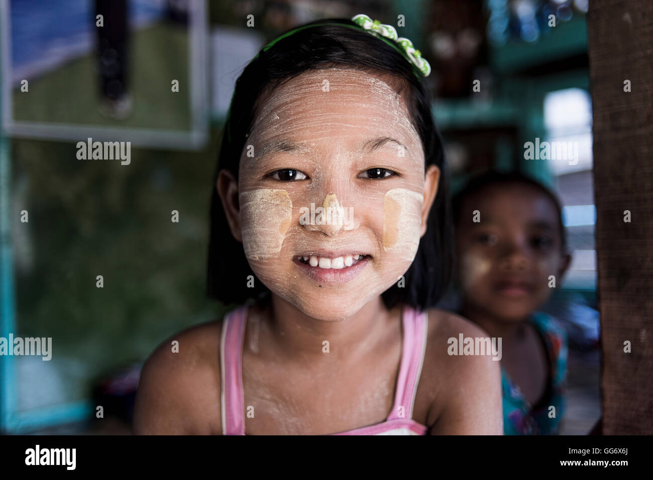Portrait of a beautiful Burmese girl wearing traditional make-up ...