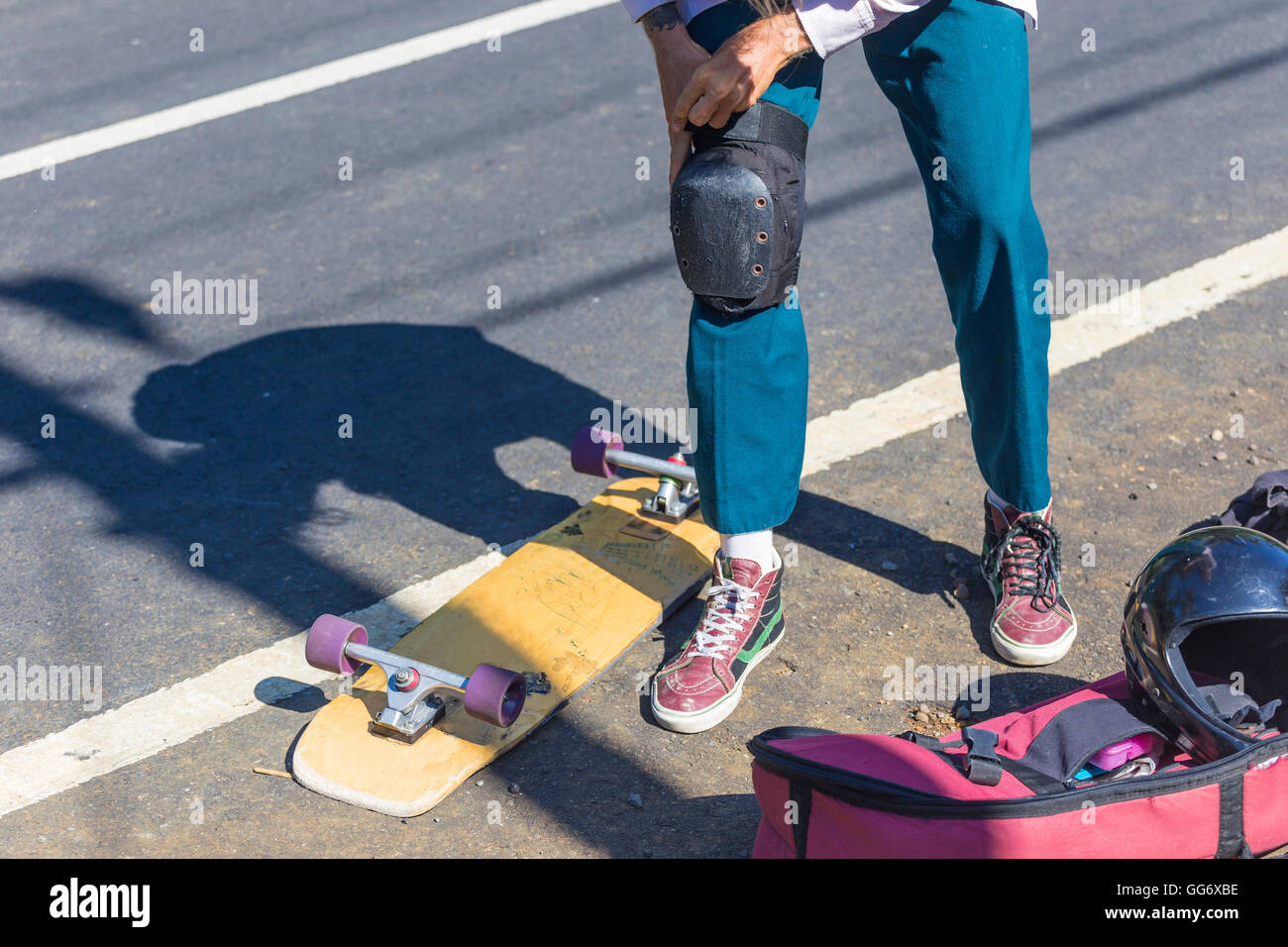 Longboarder is stretching before action Stock Photo - Alamy