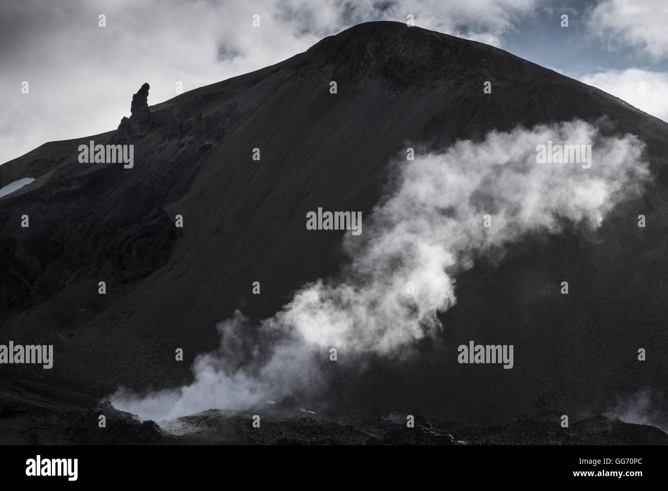 Steam rises from a volcanic geothermal vent in the mountains at ...