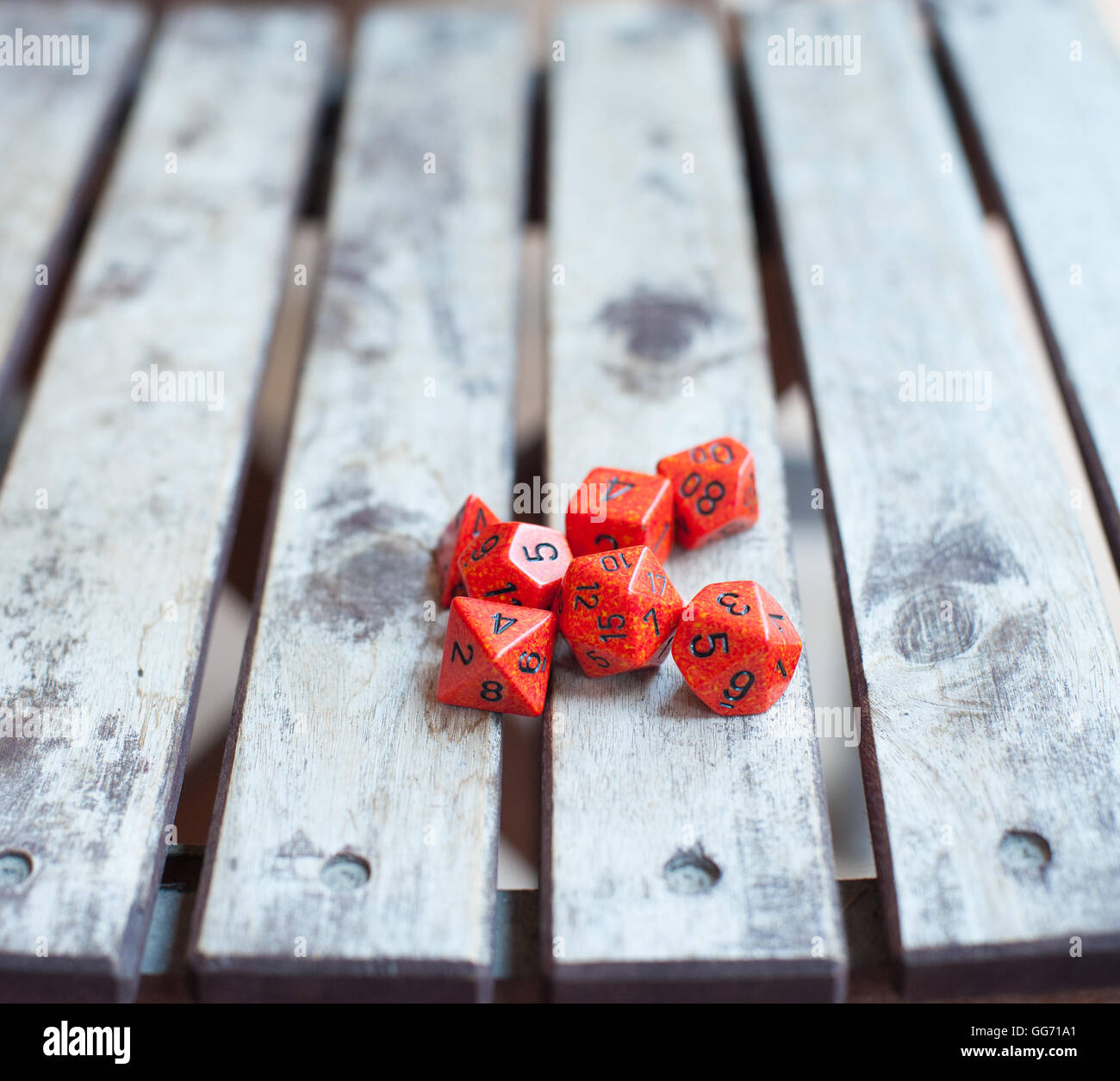 Group of different red role play baord game dice close up on wooden ...