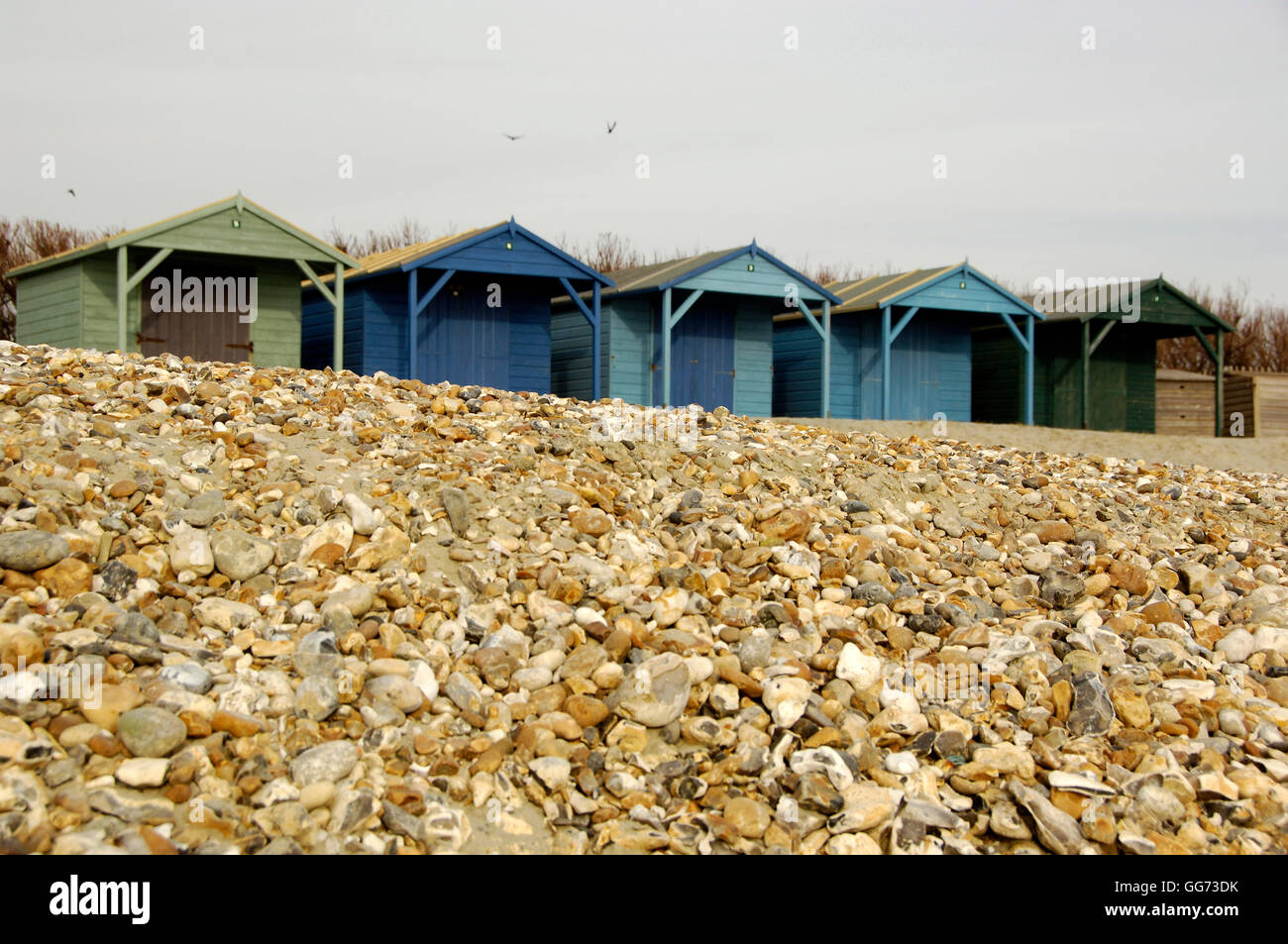 Beach huts on a shingle beach Stock Photo - Alamy
