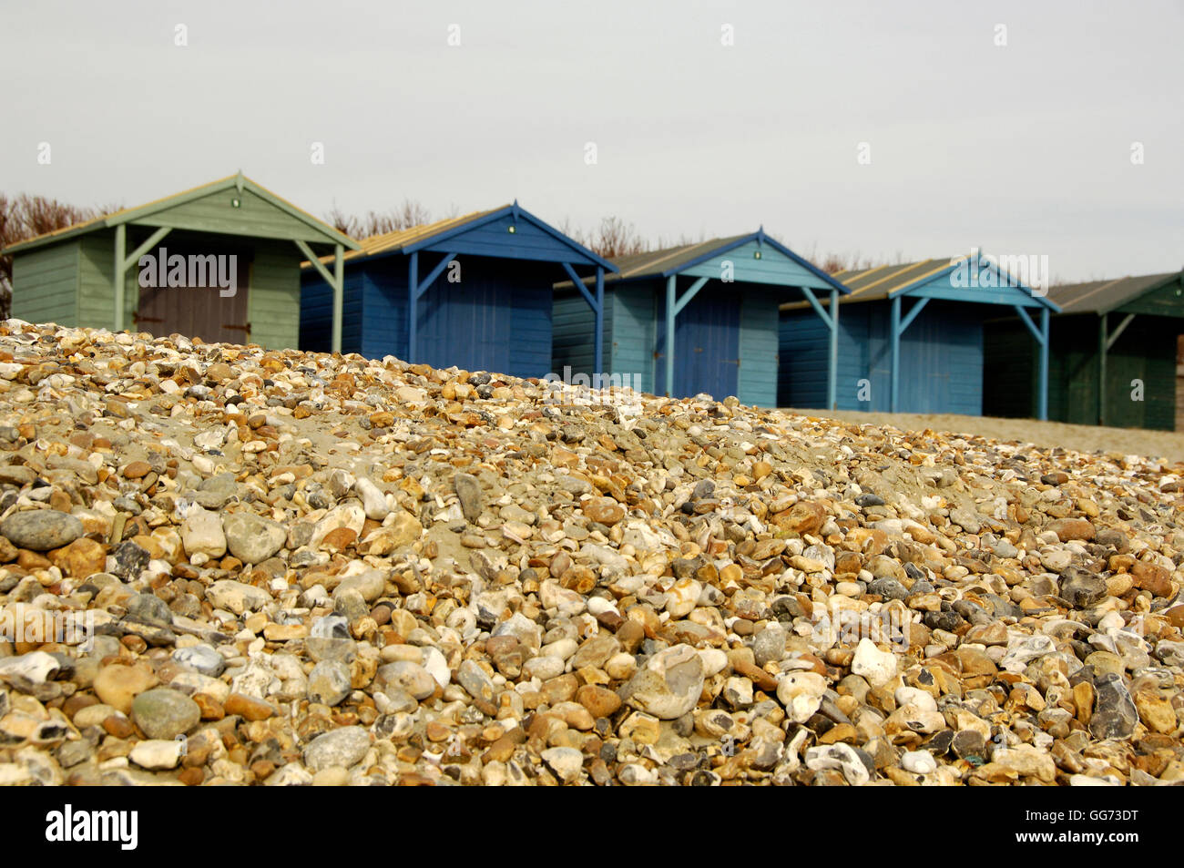 Beach huts on a shingle beach Stock Photo - Alamy