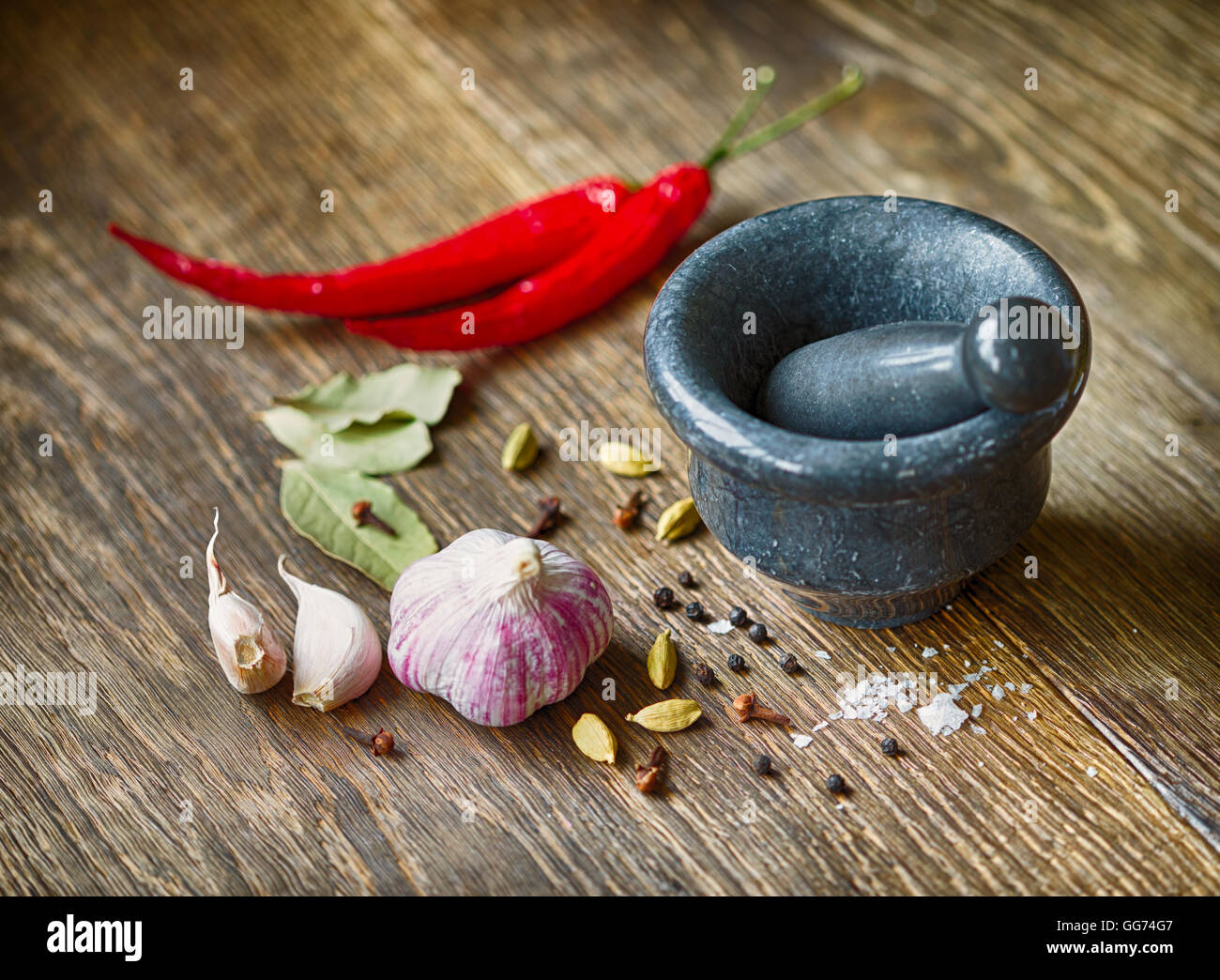Spices in wooden bowls and mortar with pestle. Cooking ingridients ...