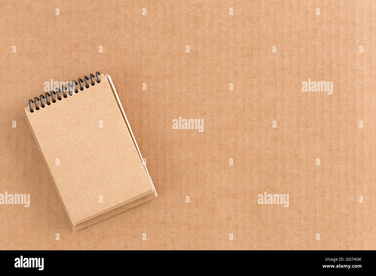 Brown cardboard notepad on corrugated cardboard background Stock Photo ...