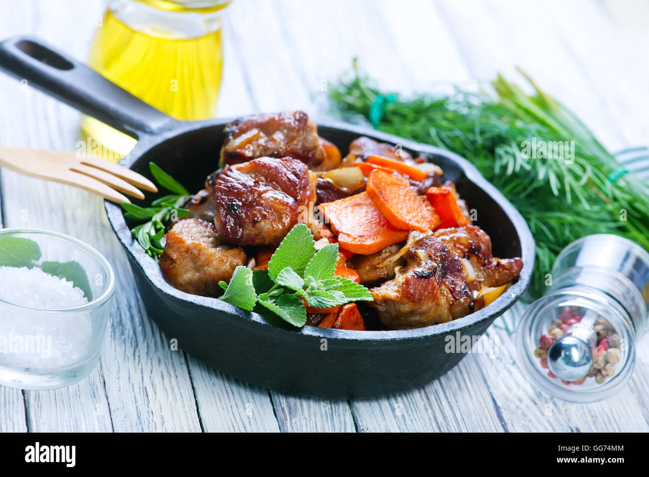 fried meat with vegetables in the pan Stock Photo - Alamy
