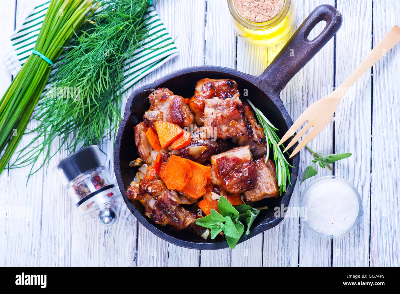 fried meat with vegetables in the pan Stock Photo - Alamy