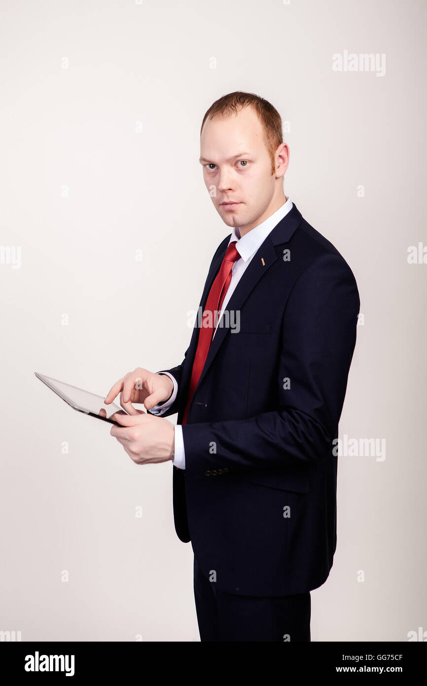 Creative young programmer in a business suit with a tie and sunglasses ...